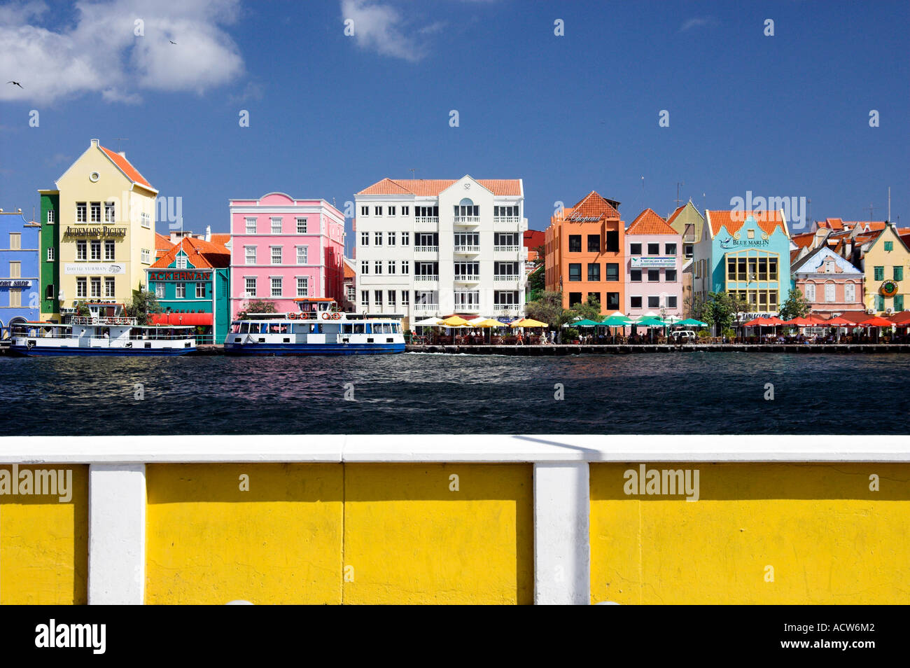 Brightly colored buildings with Dutch colonial architecture line the ...