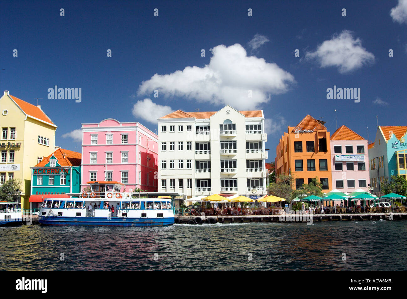 Brightly colored buildings with Dutch colonial architecture line the ...