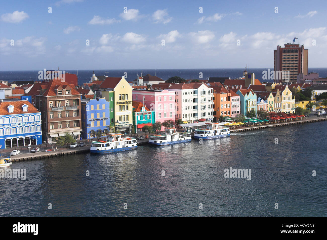 Brightly colored buildings with Dutch colonial architecture line the ...
