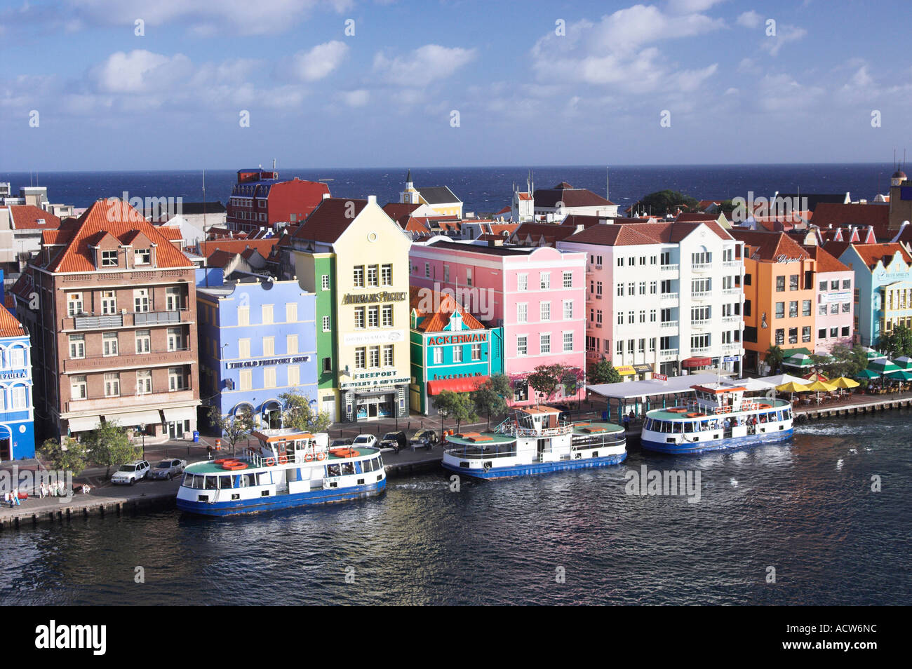 Brightly colored buildings with Dutch colonial architecture line the ...