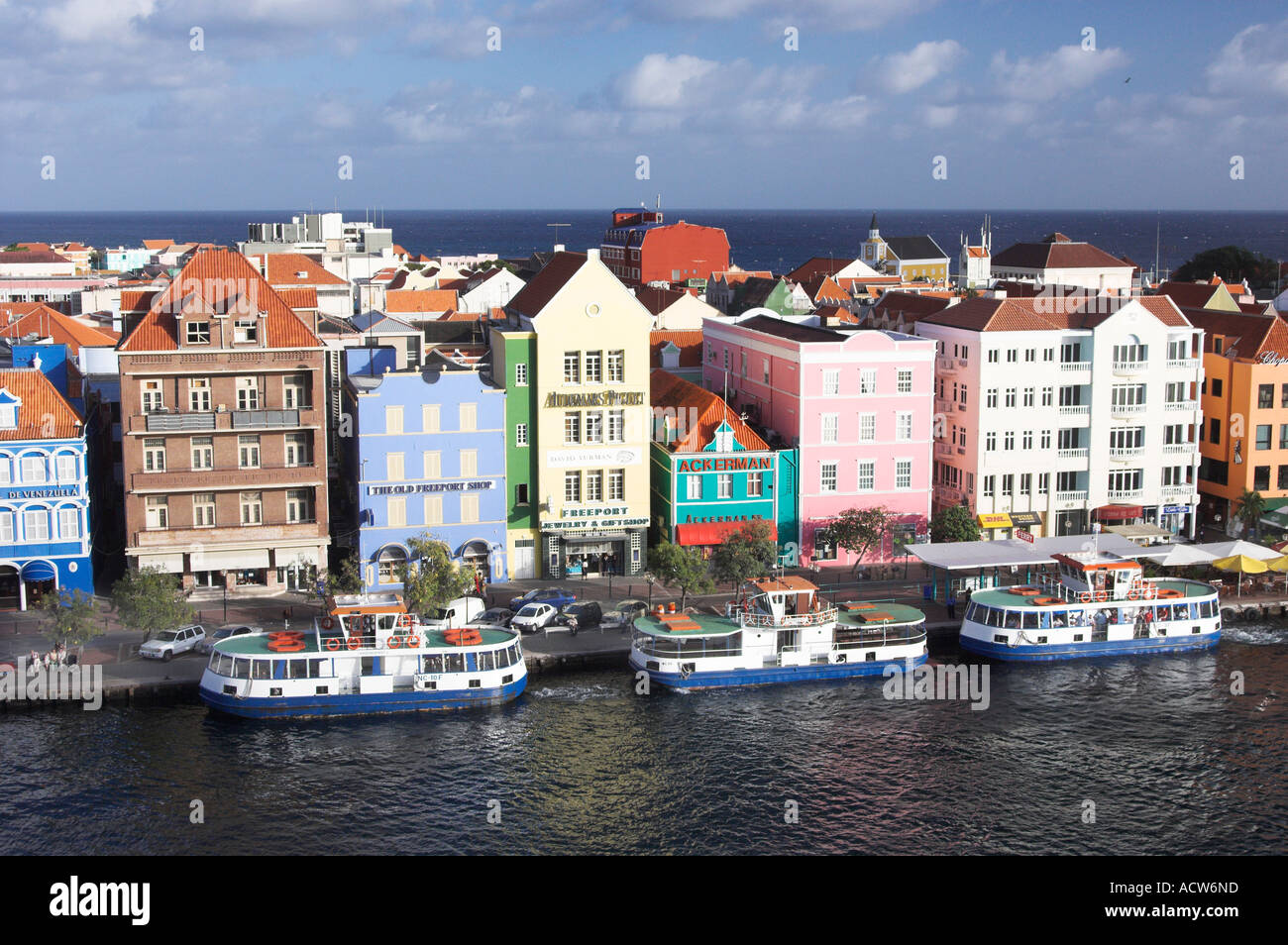 Brightly colored buildings with Dutch colonial architecture line the ...