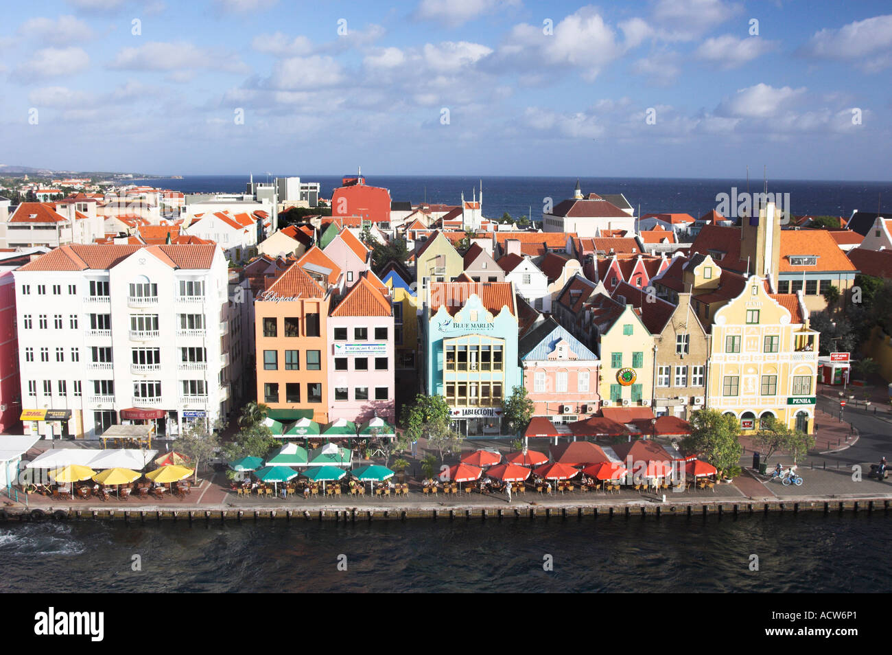 Brightly colored buildings with Dutch colonial architecture line the ...