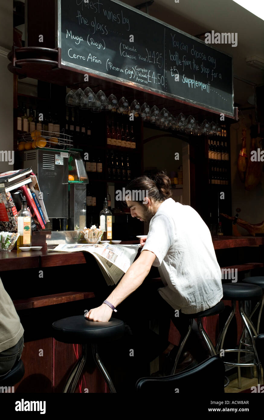 Tapas bar with bar man and man sitting at bar hi-res stock photography ...