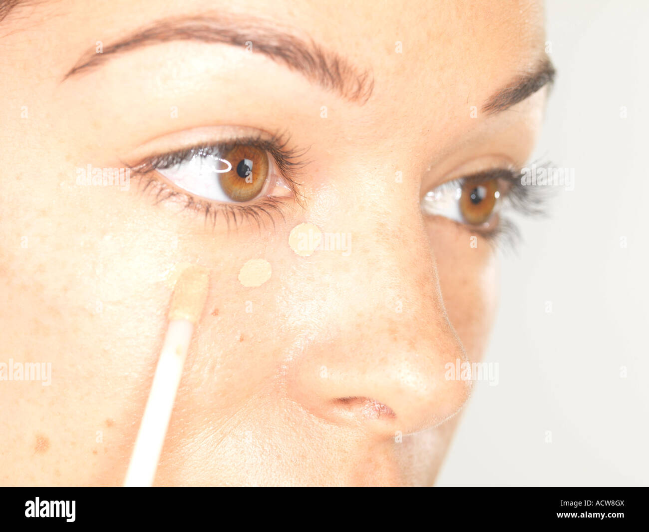 Young Woman Applying Concealer Model Released Stock Photo - Alamy