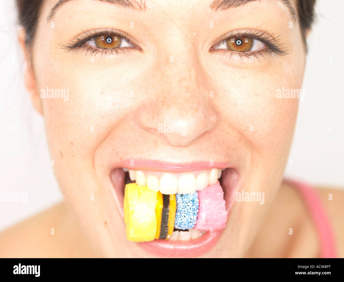 Young Woman Eating Sweets Model Released Stock Photo - Alamy