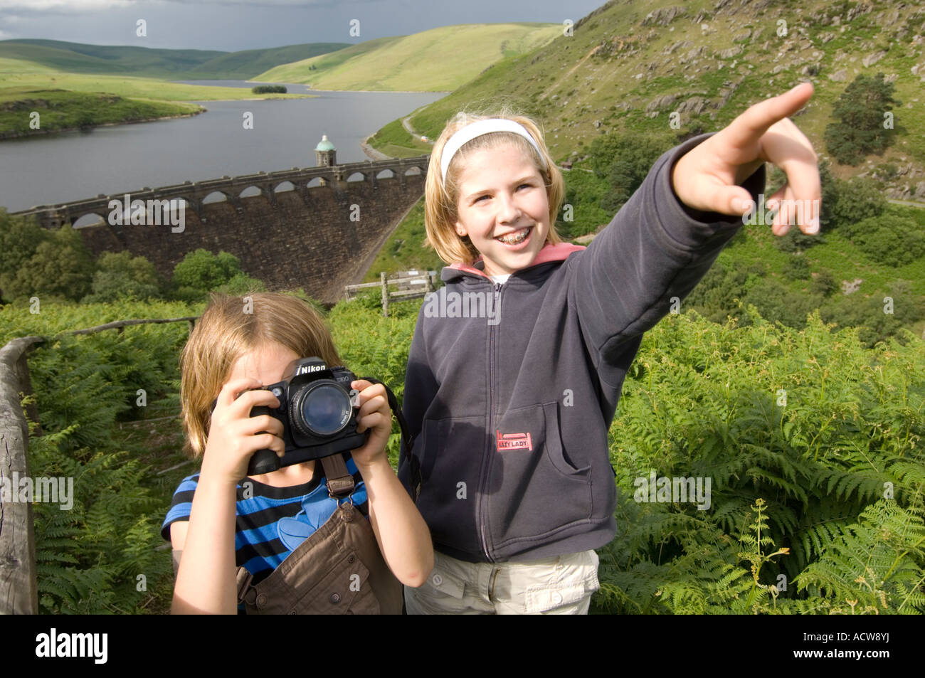two young girls photographing at Graig Goch resevoir and dam Elan ...