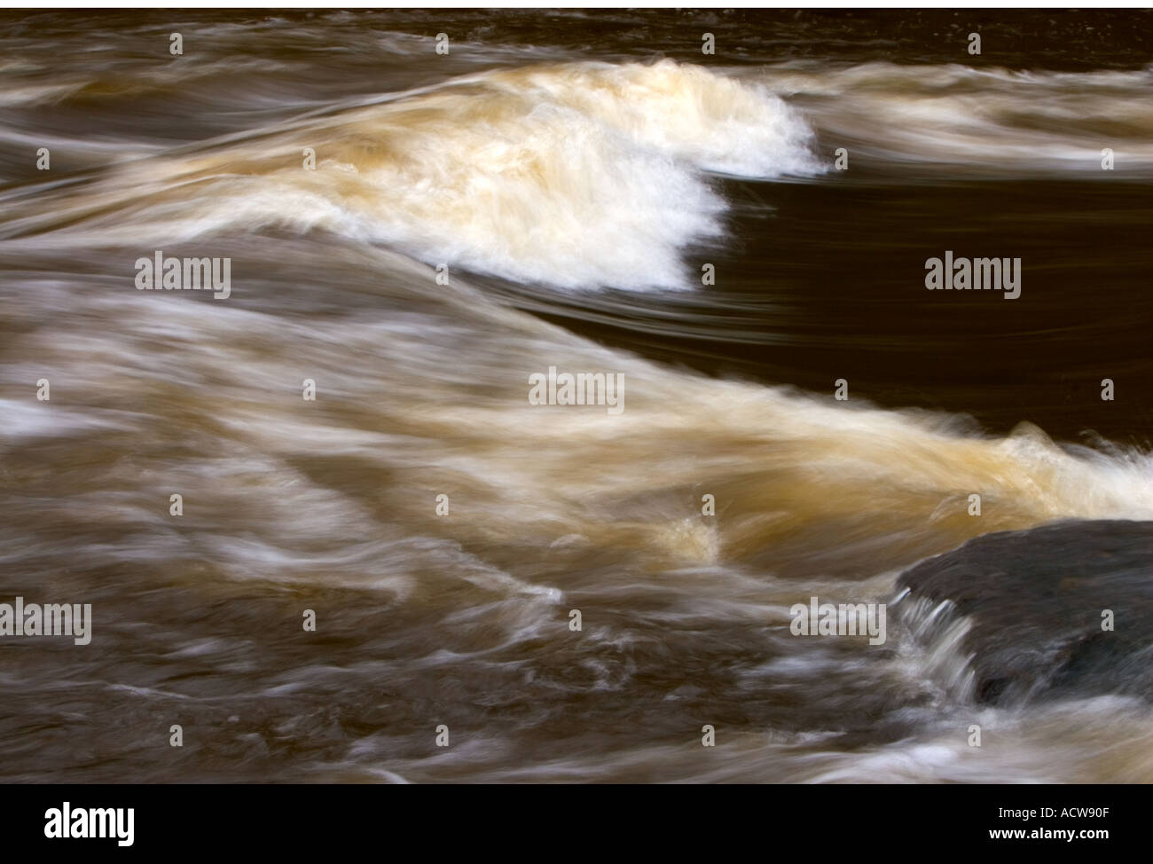 Fast flowing river irwell in flood after heavy rain, in burrs country ...