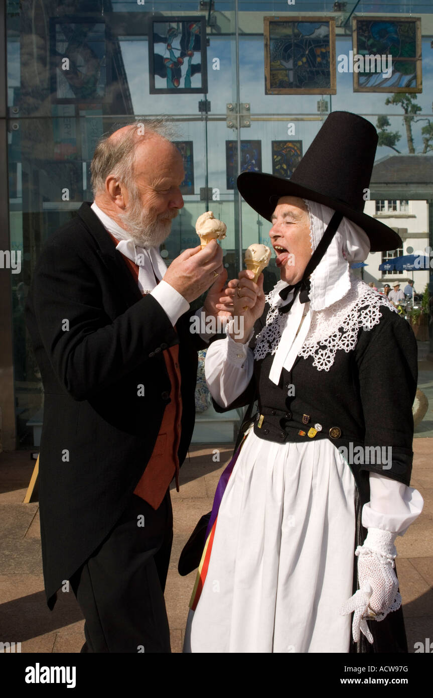 Man and woman folk dancers in traditional welsh costume eating icecream ...