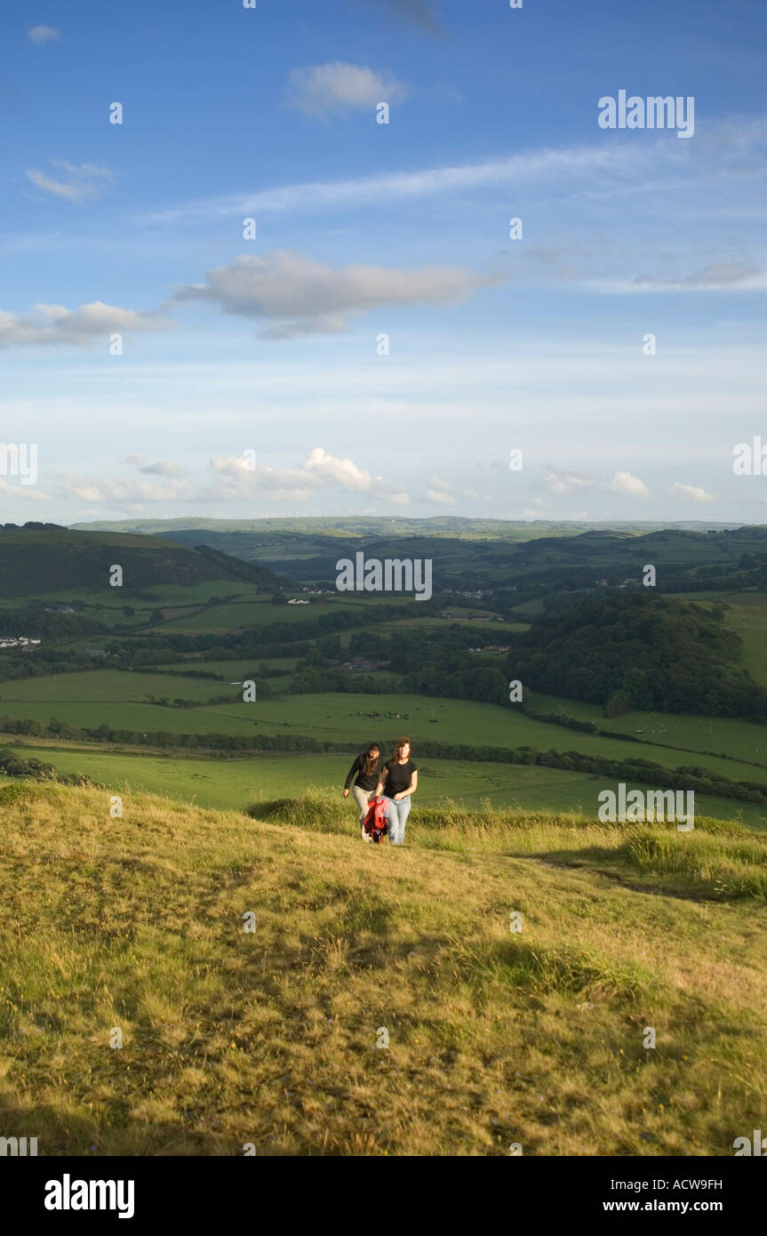 two women walking up Pen Dinas hill fort Aberystwyth with the Ystwyth ...
