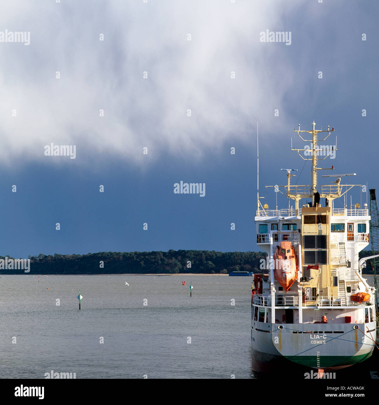 Cargo Ship In Port Under Storm Clouds Alongside A Quay Loading Or ...