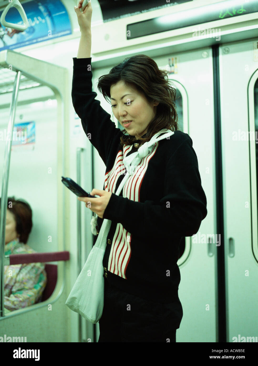 Commuter text messaging Stock Photo - Alamy