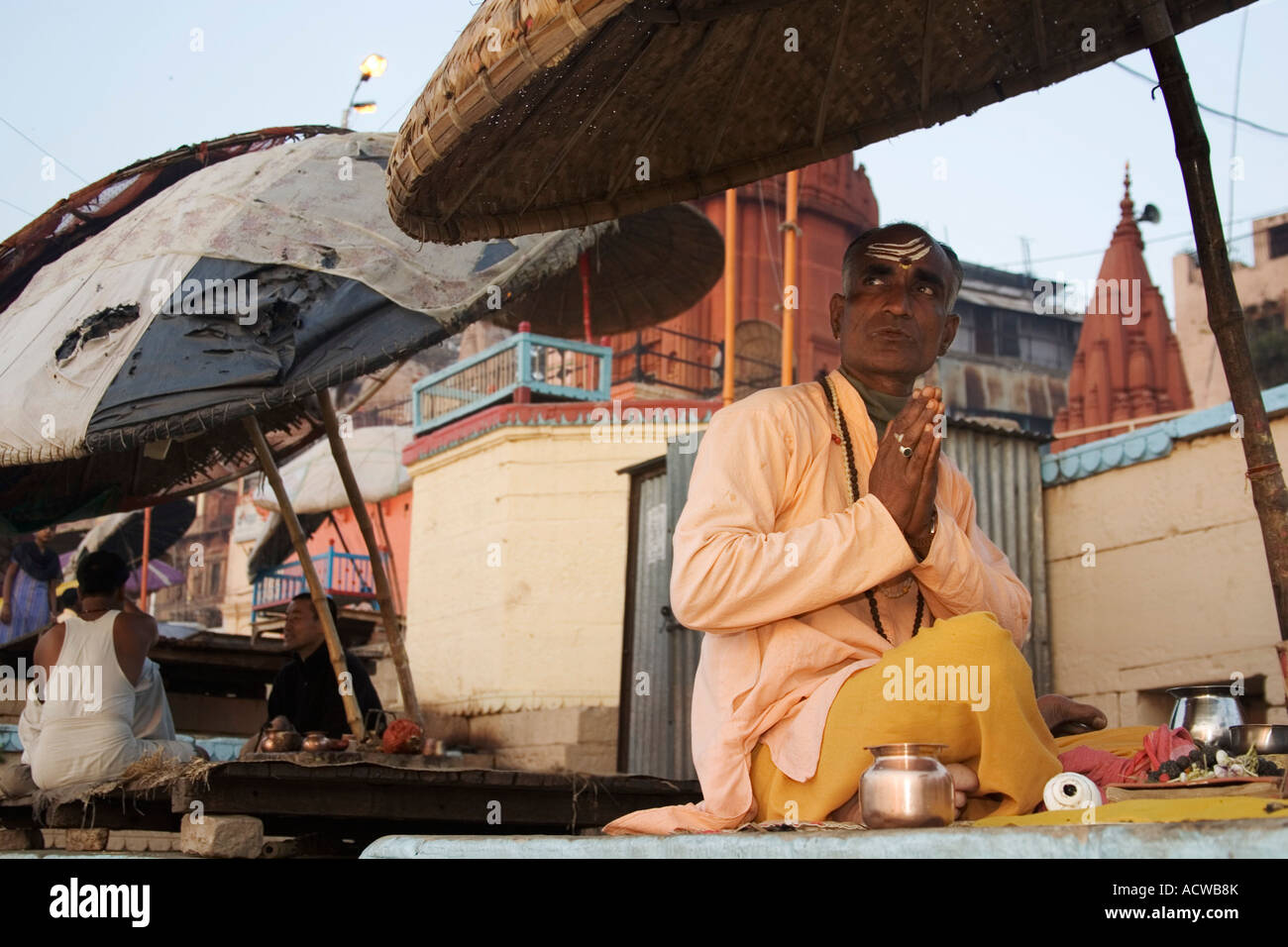 Holy man praying in the Gaths Varanasi Benares India Stock Photo - Alamy