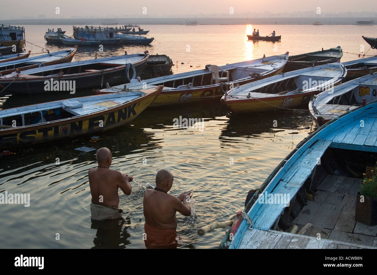 Men praying between boats in the Ganges Varanasi Benares India Stock ...
