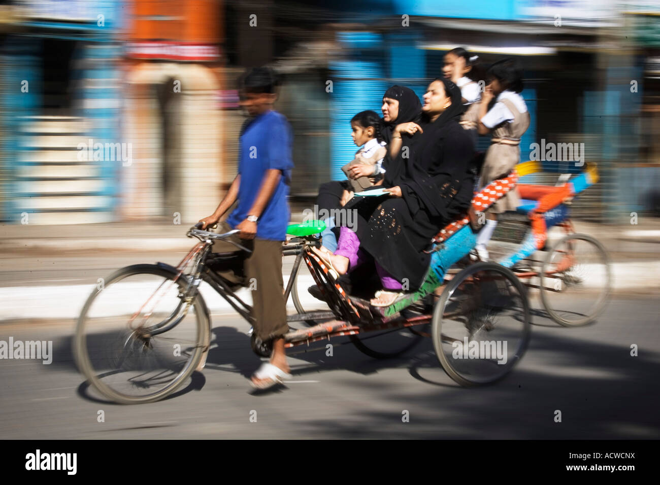 Family going to school in a rickshaw Delhi India Stock Photo - Alamy