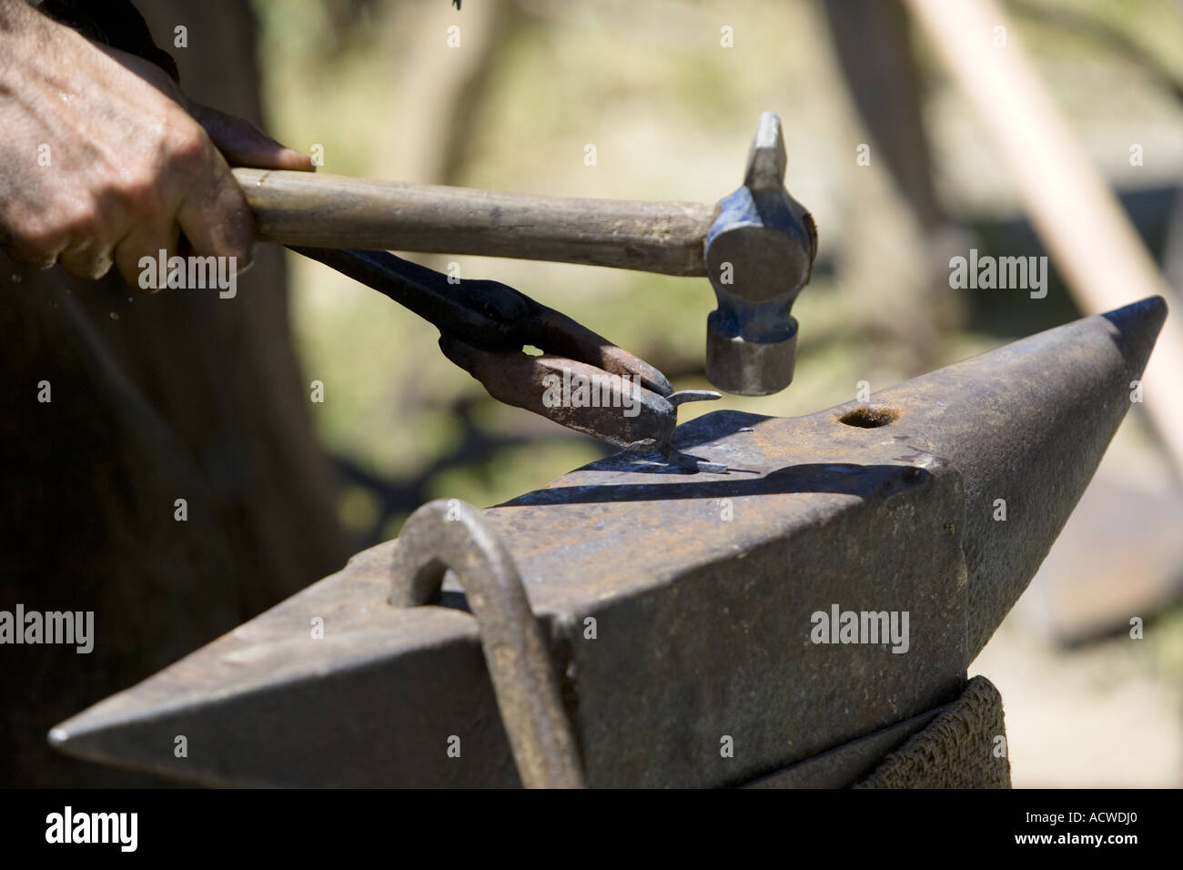 Blacksmith Using Hammer On Anvil At Medieval Fair At Butron Castle Near