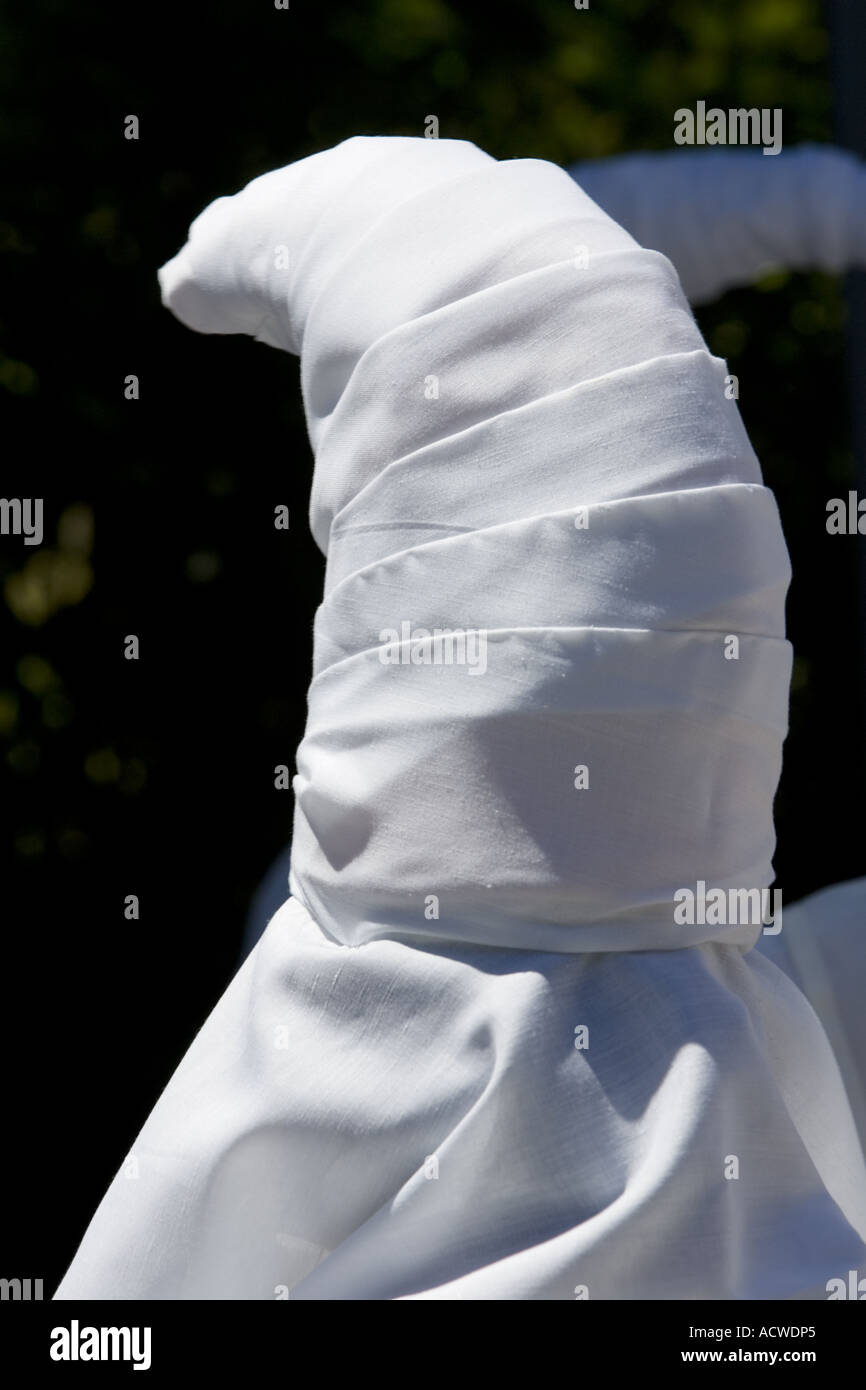 Rear view of woman wearing traditional horn shaped Basque burukoa ...