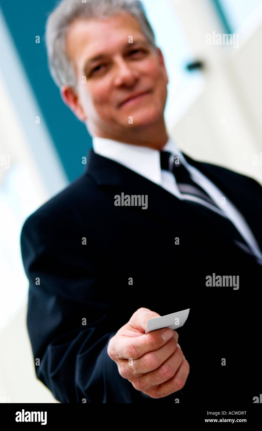 Businessman handing out business card Stock Photo - Alamy