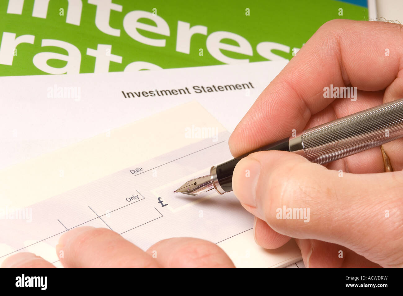 Close up of man writing cheque with fountain pen Stock Photo - Alamy