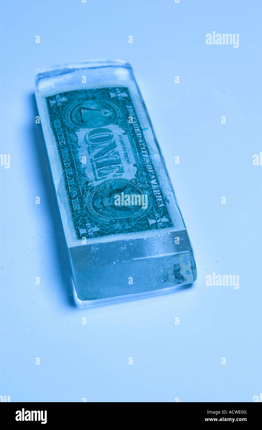Block of ice with money inside Stock Photo - Alamy