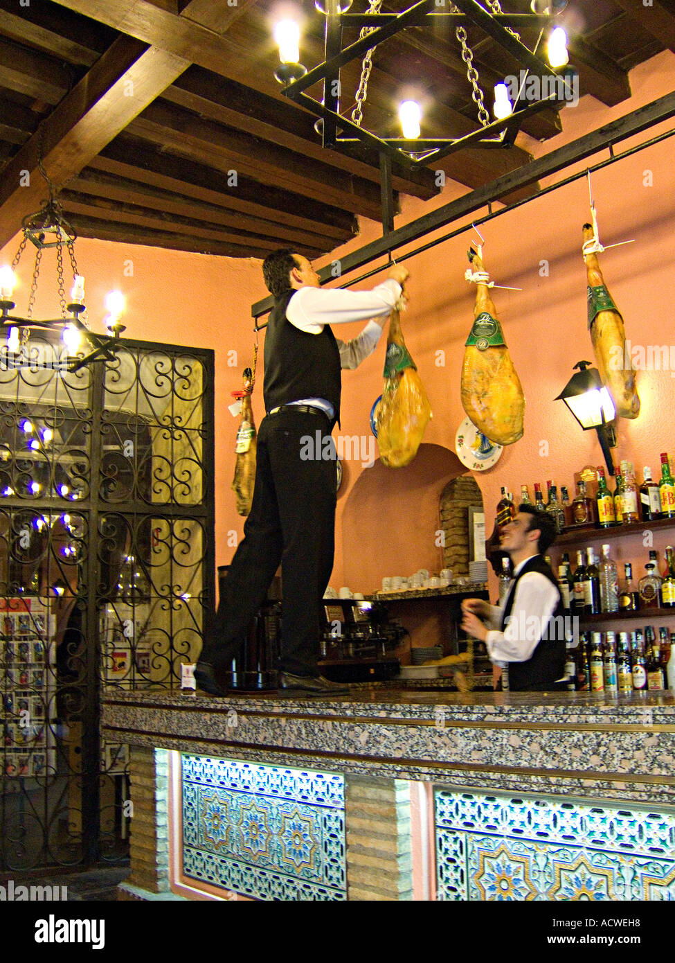Cured ham hanging in restaurant hi-res stock photography and images - Alamy