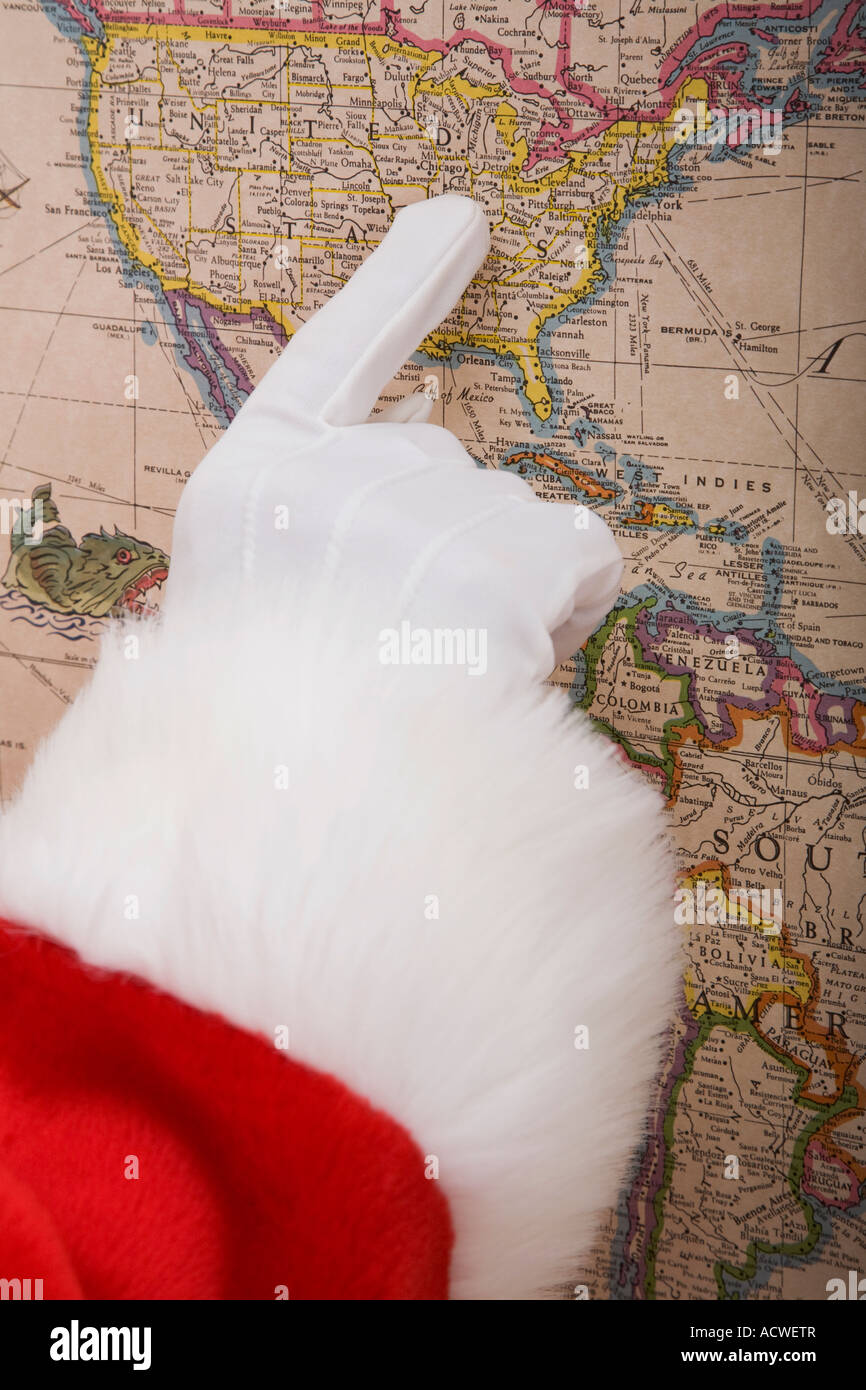 Santa pointing at map Stock Photo - Alamy