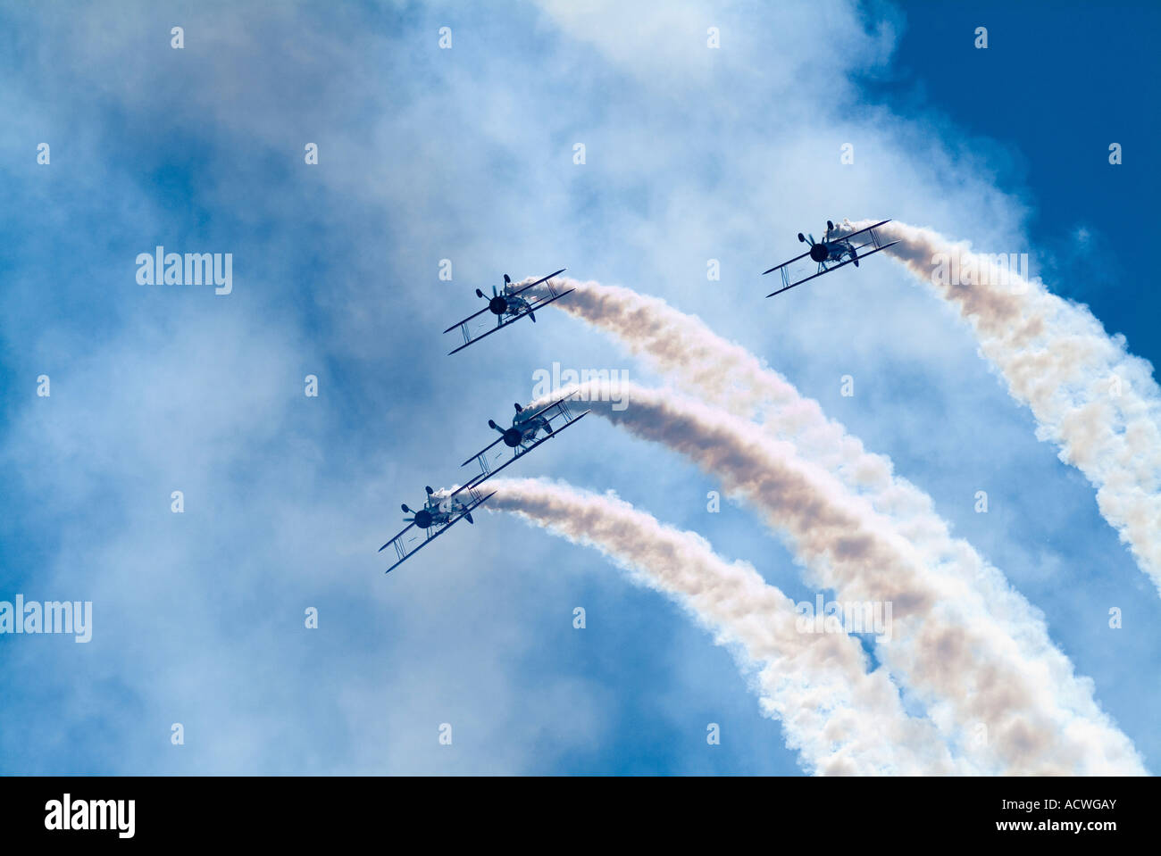 FOUR WORLD WAR II BI PLANES FLYING UP SIDE DOWN IN A FORMATION WHILE ...