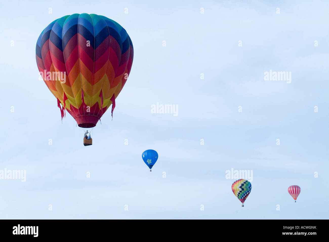 FOUR HOT AIR BALLOONS FLYING IN A ROW Stock Photo - Alamy