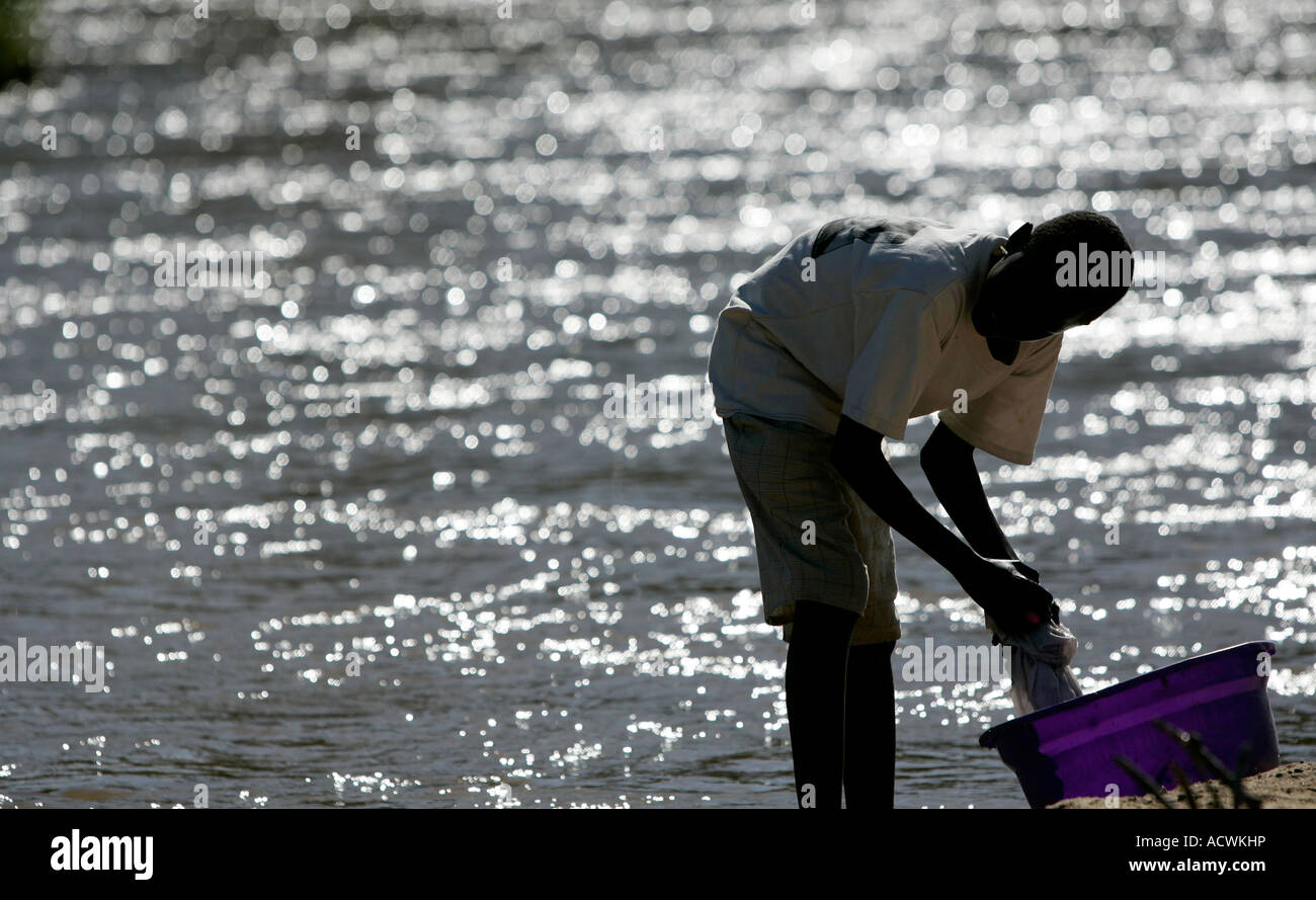 African boy washes in river Stock Photo - Alamy