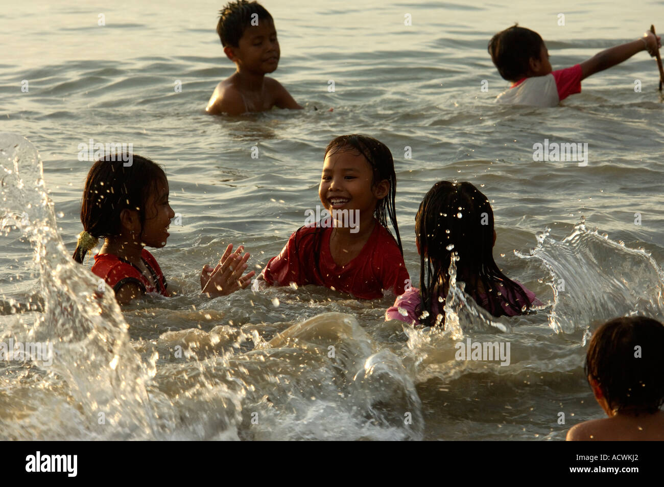 Balinese children playing in the sea Stock Photo - Alamy