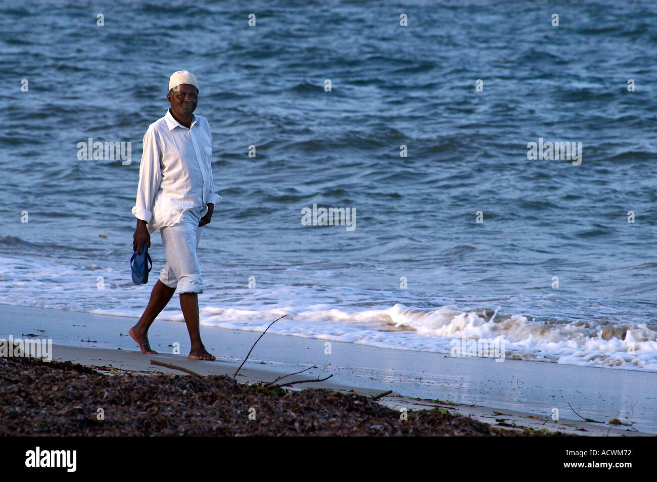 single man walking on the beach Stock Photo - Alamy