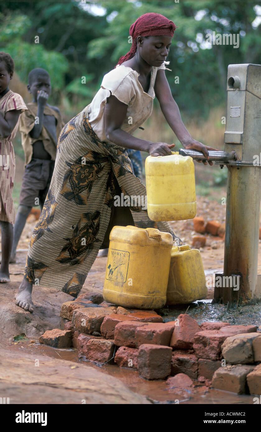 african woman pumps water at a well Stock Photo - Alamy