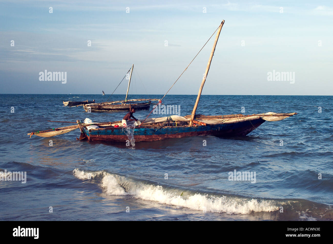 african fisherman working on his old dhau Stock Photo - Alamy