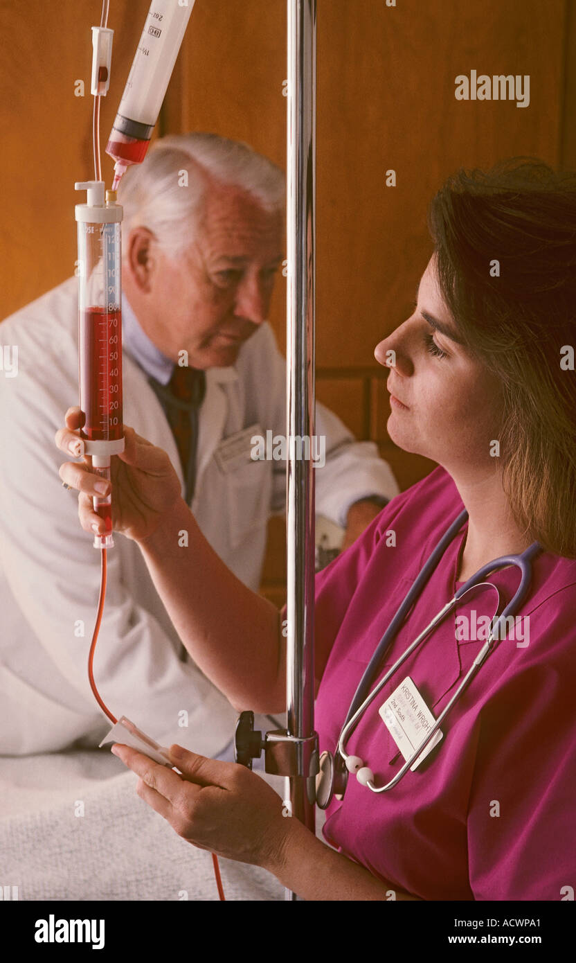 doctor and nurse attending to patient with an IV Stock Photo - Alamy
