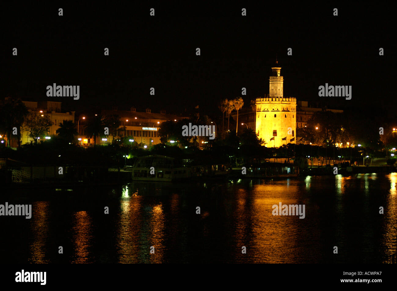 Floodlit Torre del Oro octagonal tower by river Guadalquivir Seville ...