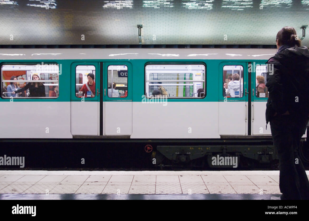 A color horizontal image of a train in an underground station in the ...