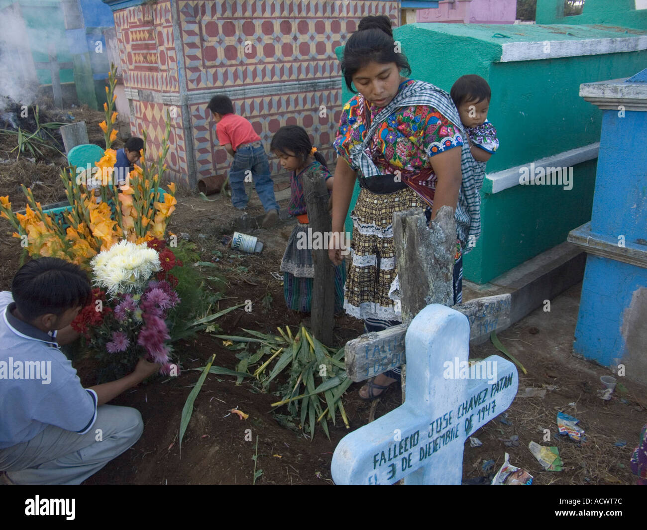 Indigenous families visit the graves of relatives to celebrate day of ...