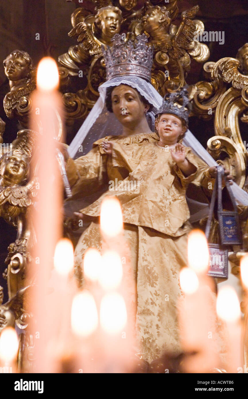 Detail of Christian statue of Madonna and child on gilded angel throne ...