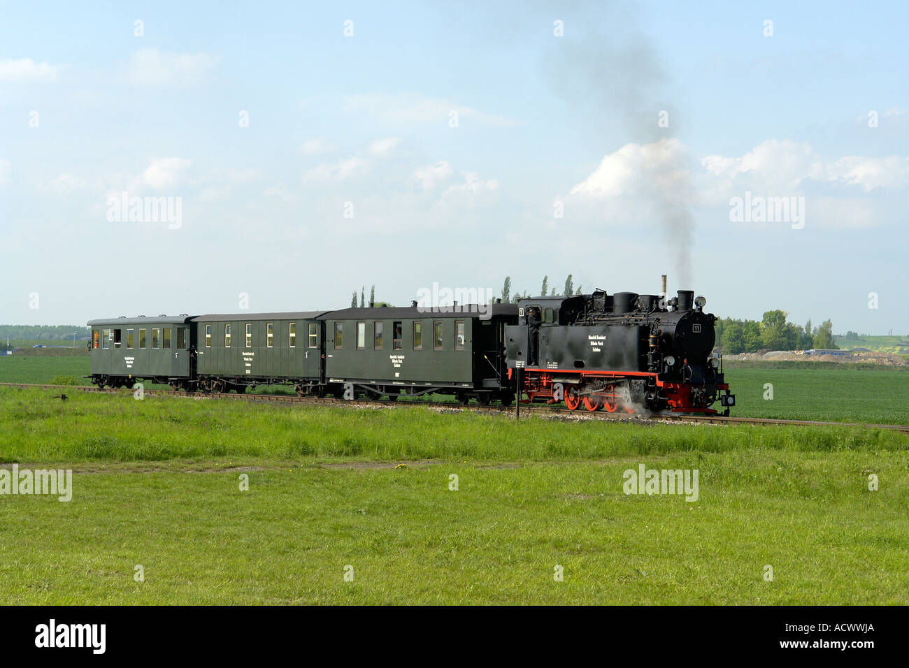 Steam powered tank engine No 11 pulling a three coach train on the ...