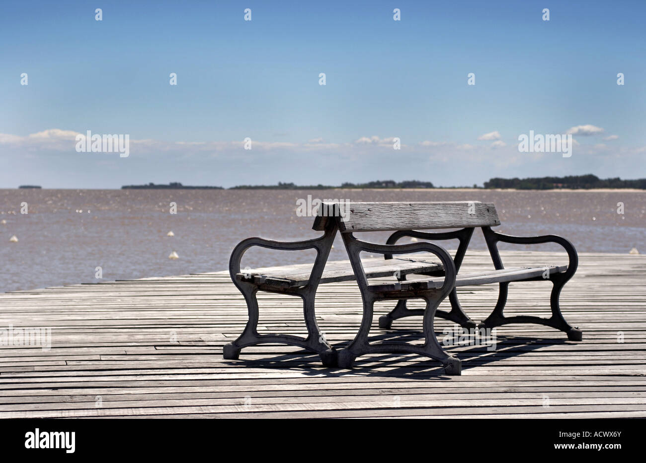Peaceful river scene with a bench, the river and blue sky Stock Photo ...