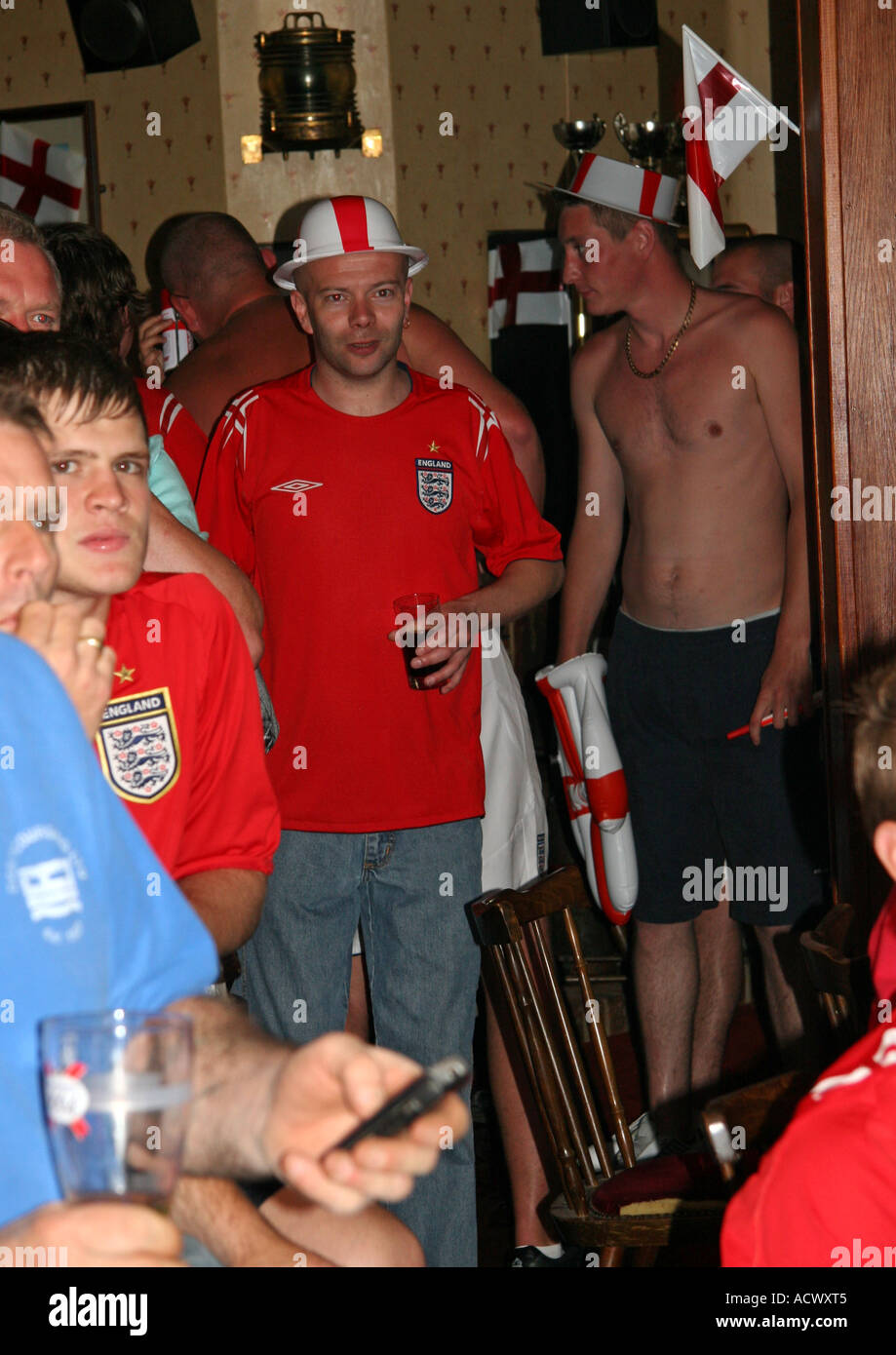 fans wearing football shirts and red and white hat Stock Photo - Alamy