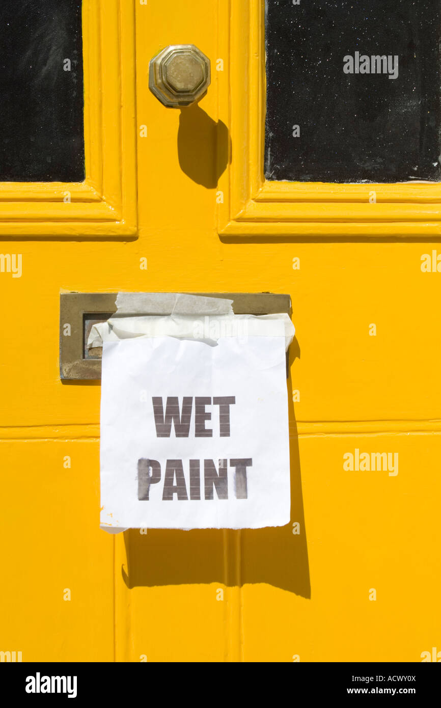 Wet Paint Sign on a Yellow Front Door Stock Photo - Alamy