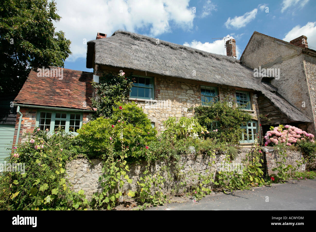 Traditional English thatched cottage in the picturesque village of ...