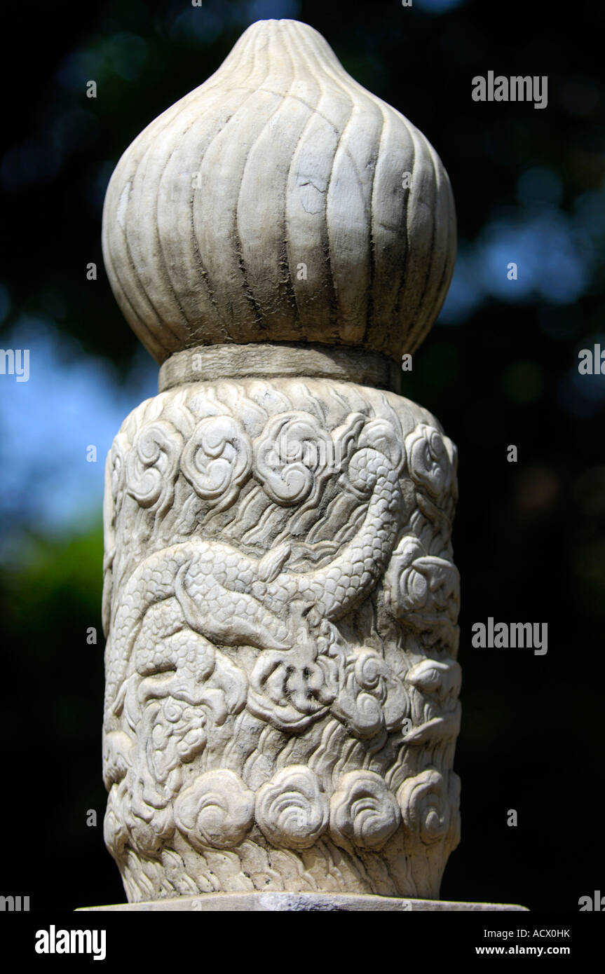 Detail of a dragon carving on a marble post in the White Cloud Temple ...