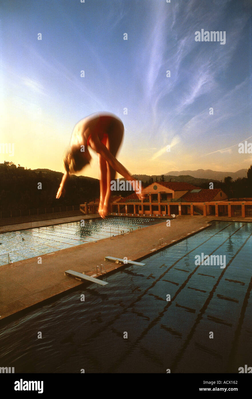 A national champion young woman practices her precision dives in ...