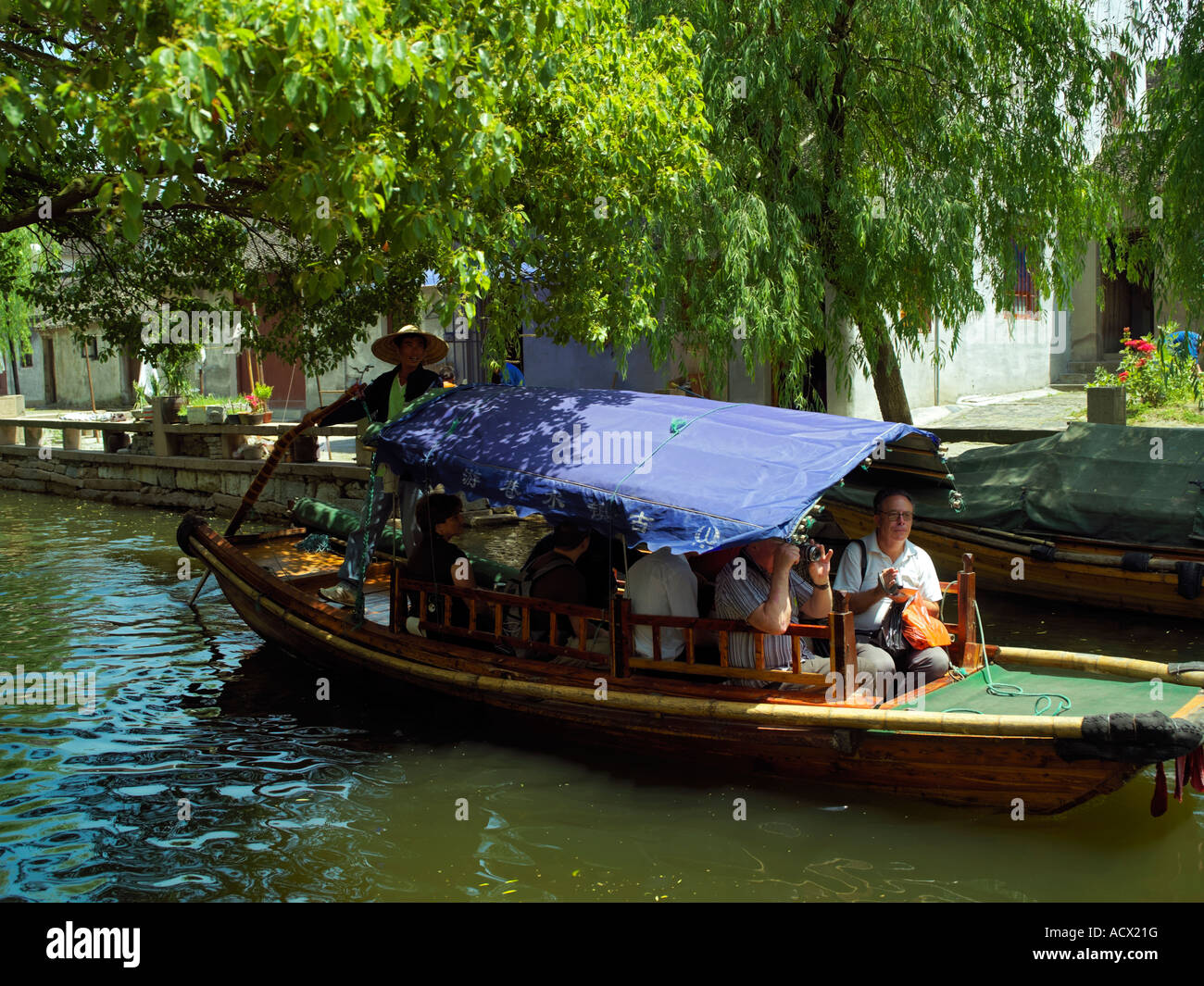 Boats carrying Chinese tourists on the old canals of Zhouzhuang in ...