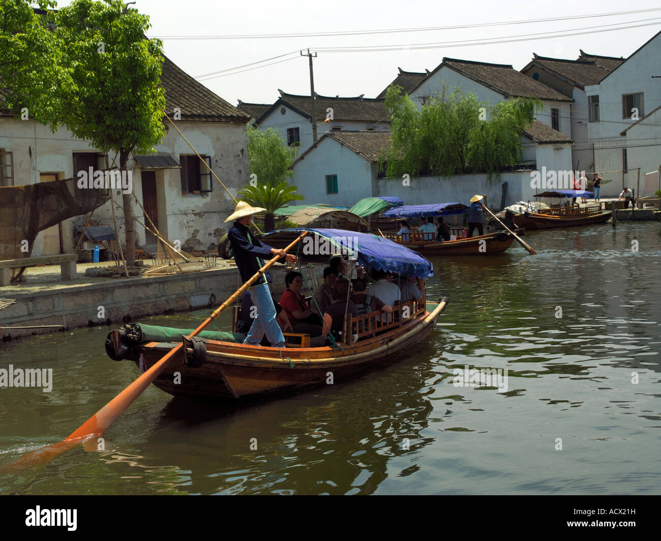 Boats carrying Chinese tourists on the old canals of Zhouzhuang in ...