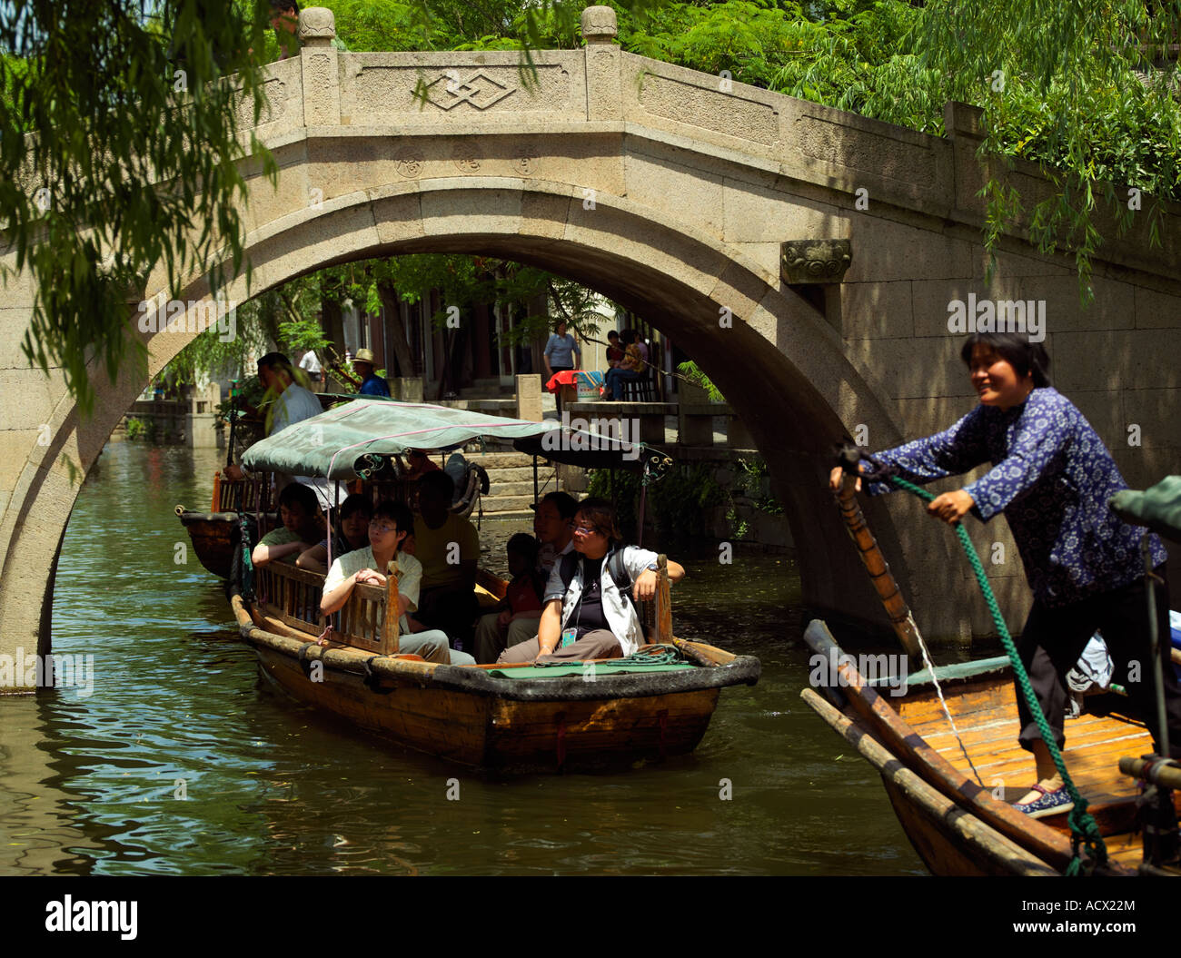 Boats carrying Chinese tourists on the old canals of Zhouzhuang in ...