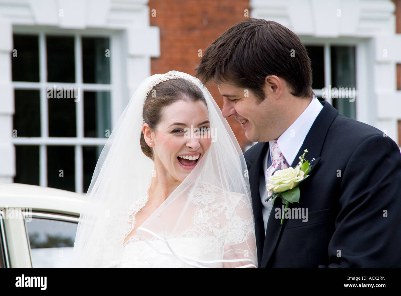 bride and groom laughing Stock Photo - Alamy