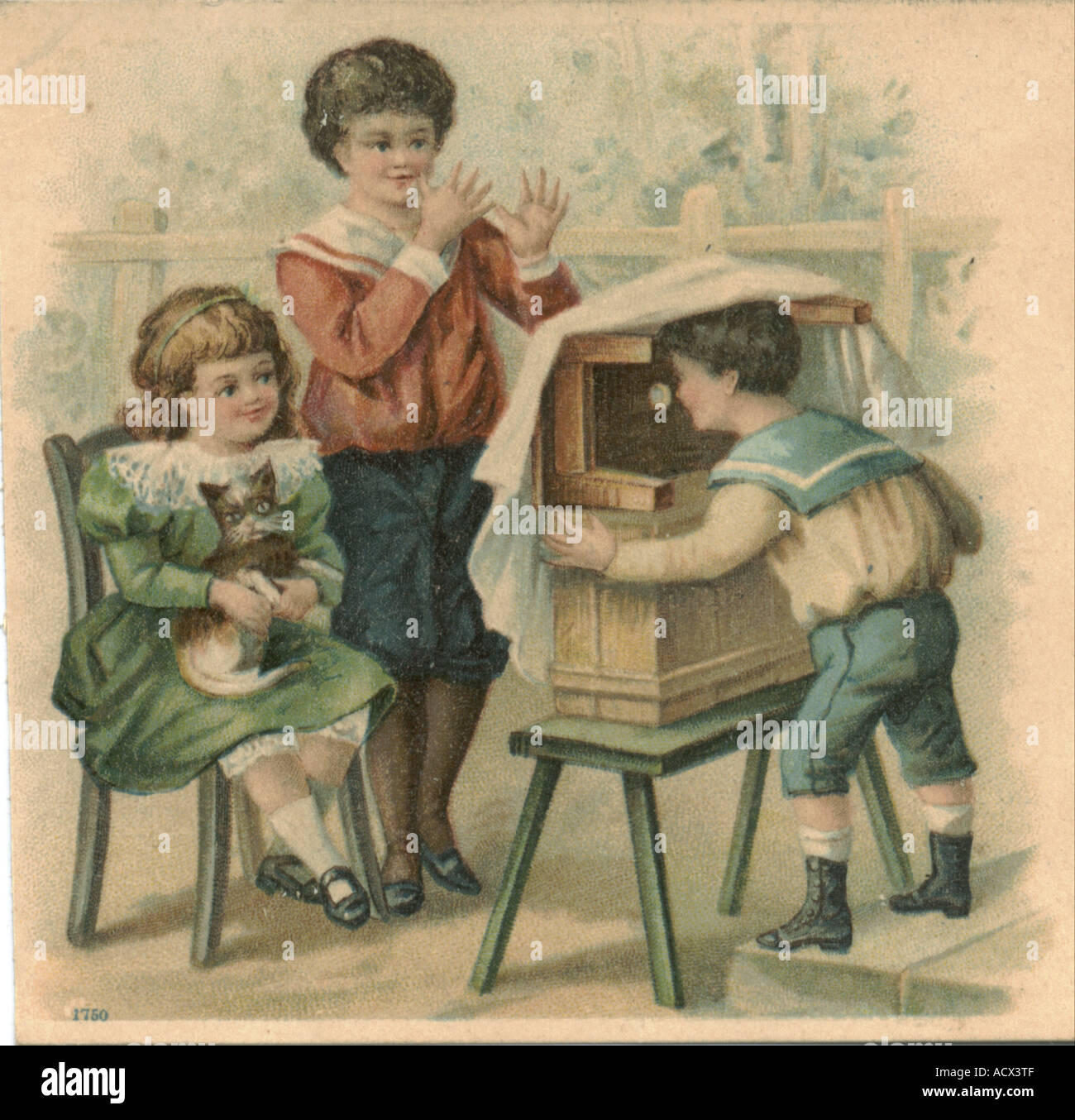 Greeting postcard showing children playing at photography circa 1905 ...
