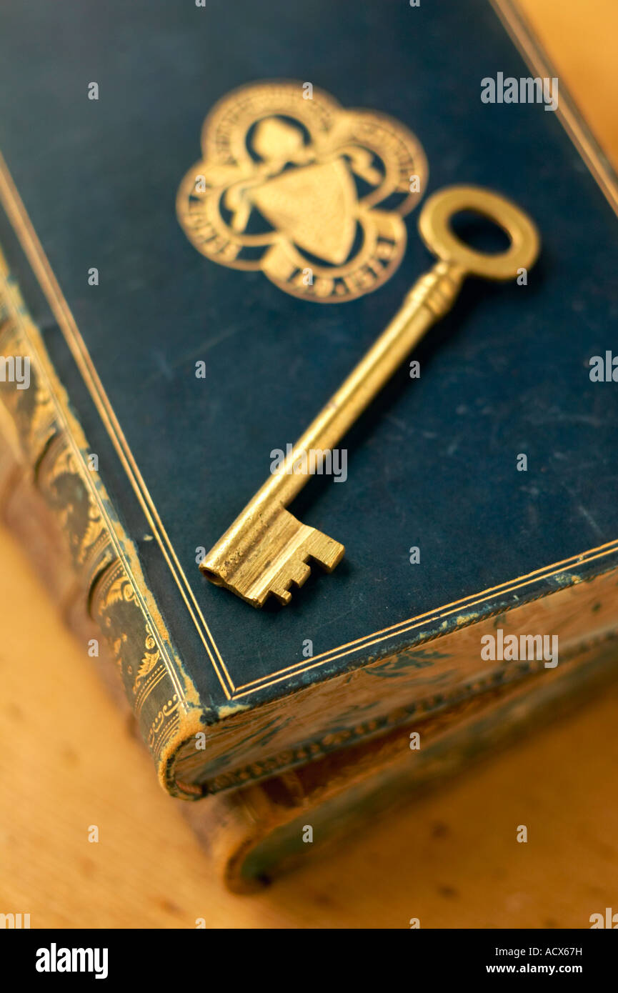 Brass antique key laying on antique leather bound books knowledge is ...